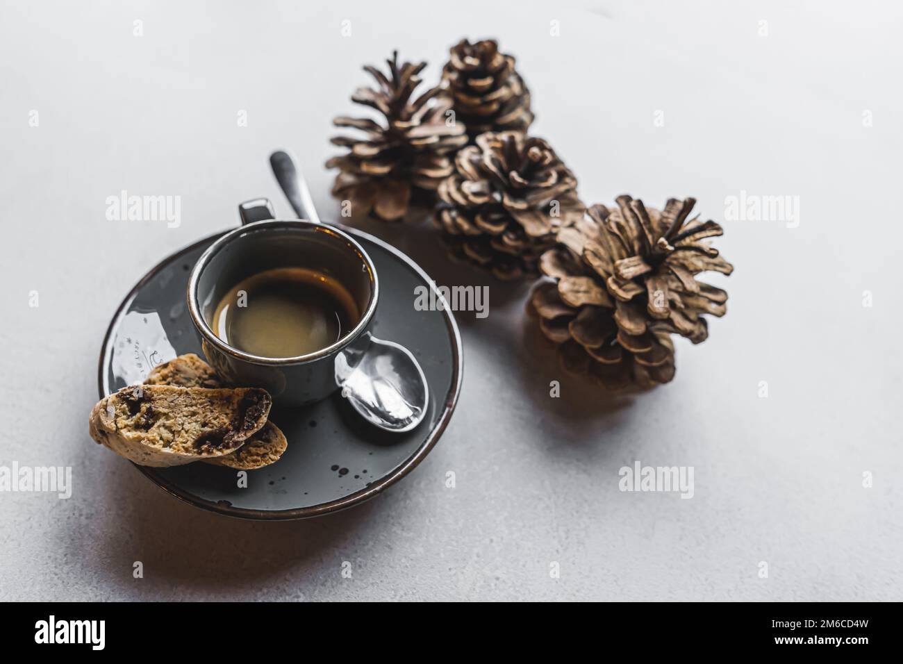 Elegant espresso coffee served with cookies standing next to four cones ...