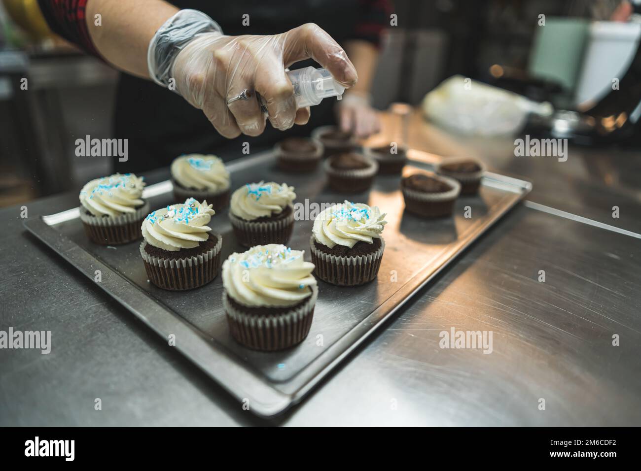 Professional equipment used in bakery. Hand pumping a spray bottle to ...