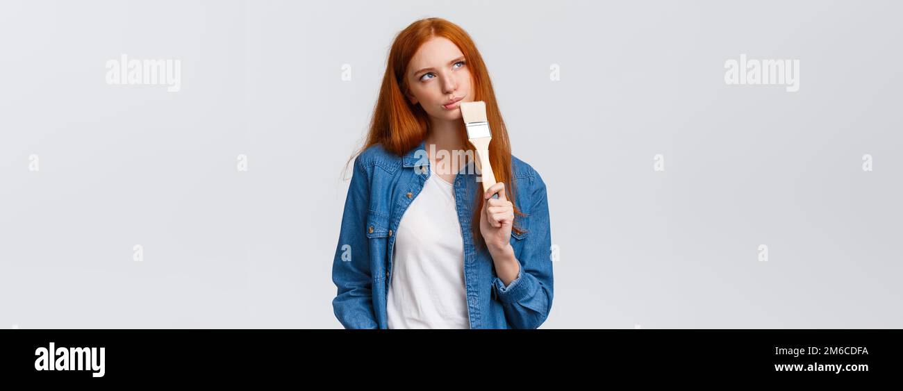 Thoughtful and creative redhead female imaging what colour paint room ...