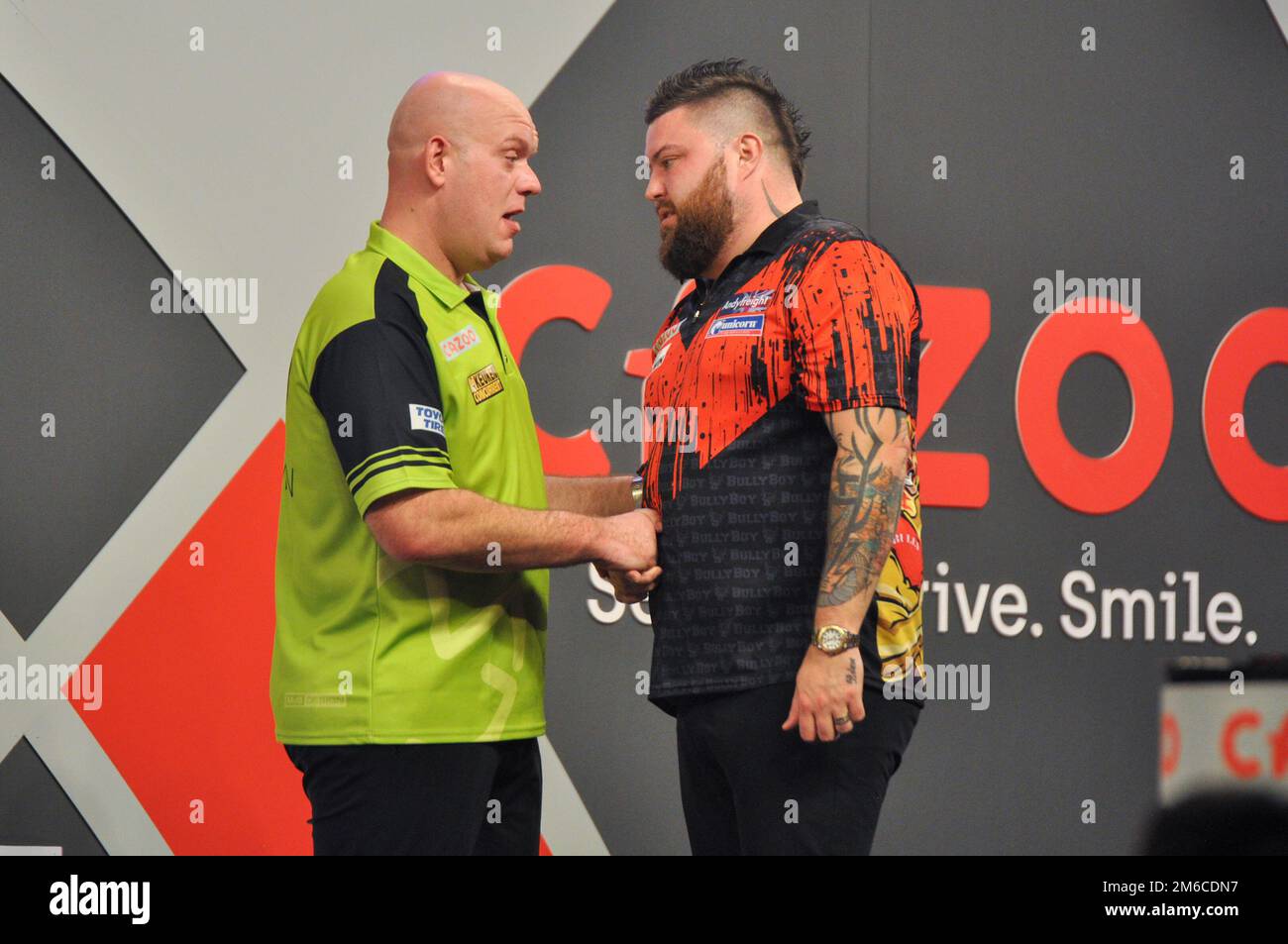LONDON, UNITED KINGDOM - JANUARY 3: Michael van Gerwen of the Netherlands interacts with Michael ...
