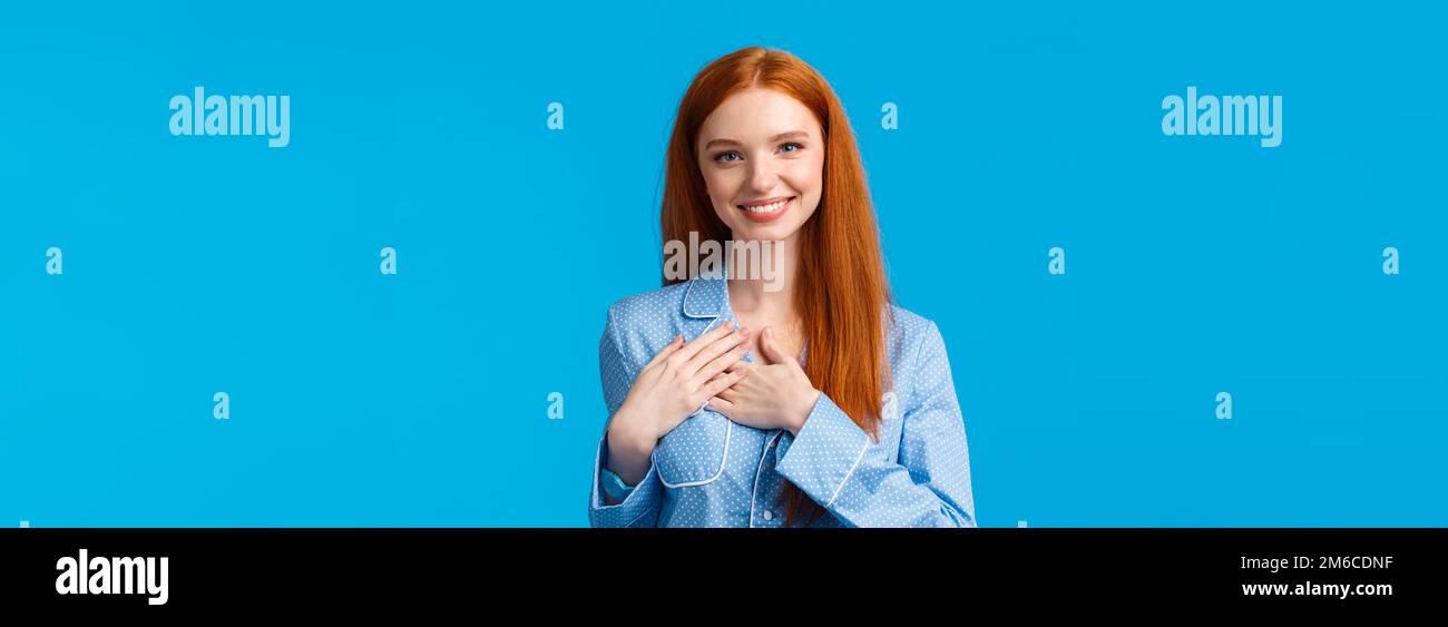 Feminine lovely redhead woman with long ginger hair, wearing pyjamas ...