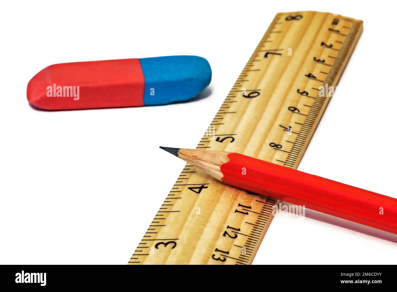 On a white background lie a ruler, eraser and a simple pencil close-up ...