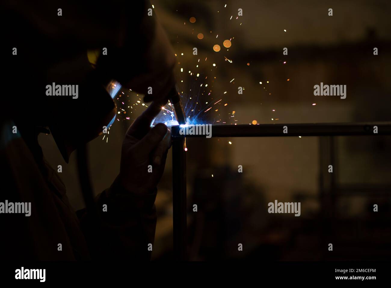 Metal welding. Sparks in dark. Welder's job Stock Photo - Alamy