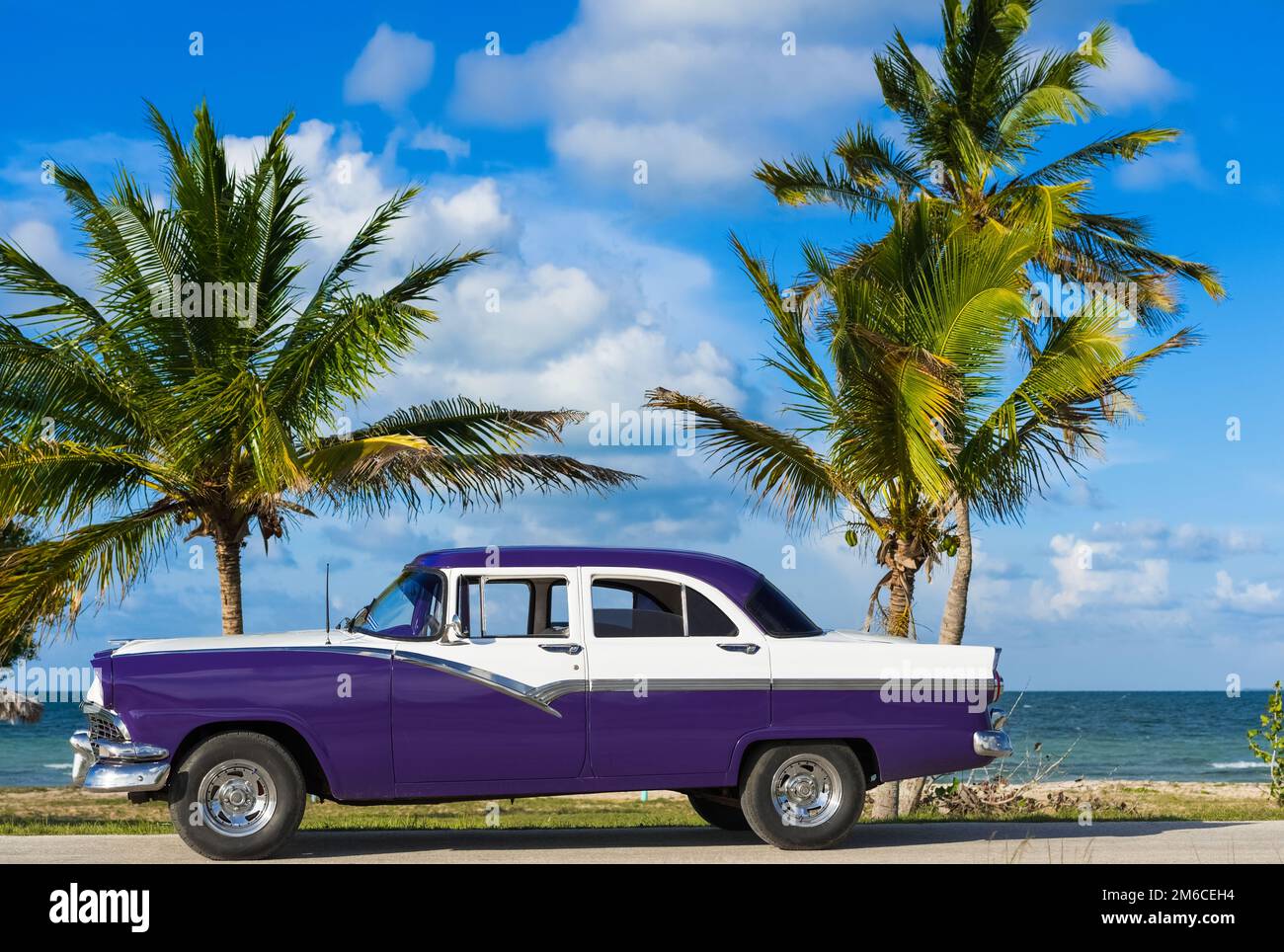 American blue classic car parked on the Malecon near the beach in ...