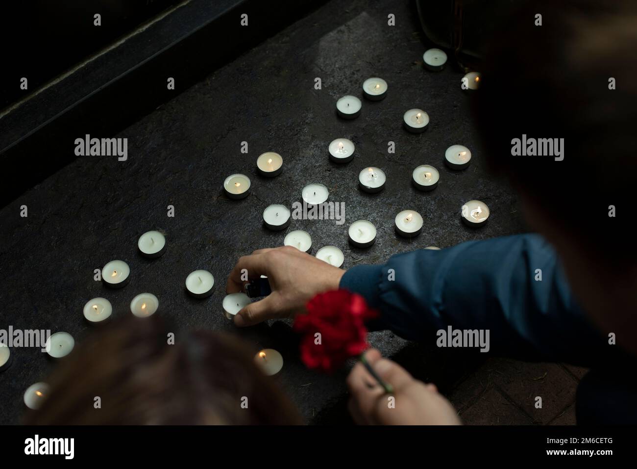 Candles on grave. Details of ceremony. Wax candles are round Stock ...