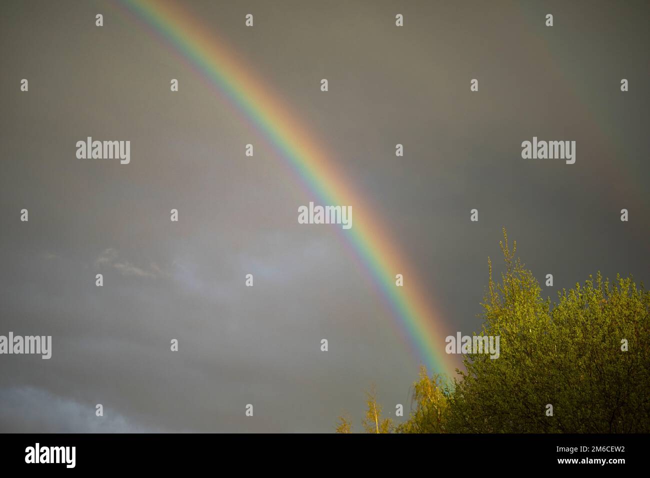Rainbow in sky. Beautiful weather. Decomposition of light into colors ...