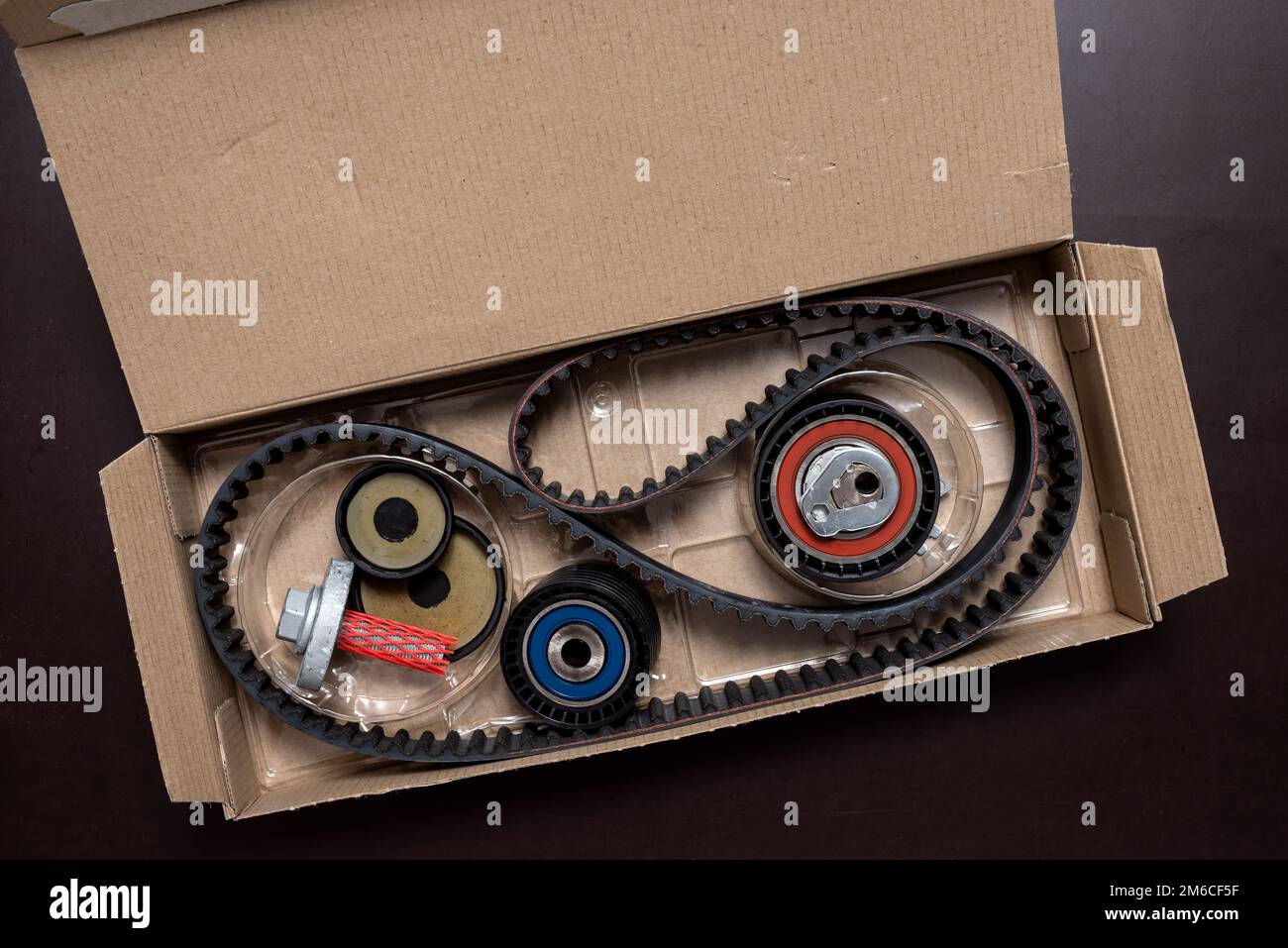 Repair kit for replacing the timing belt in a open cardboard box Stock ...