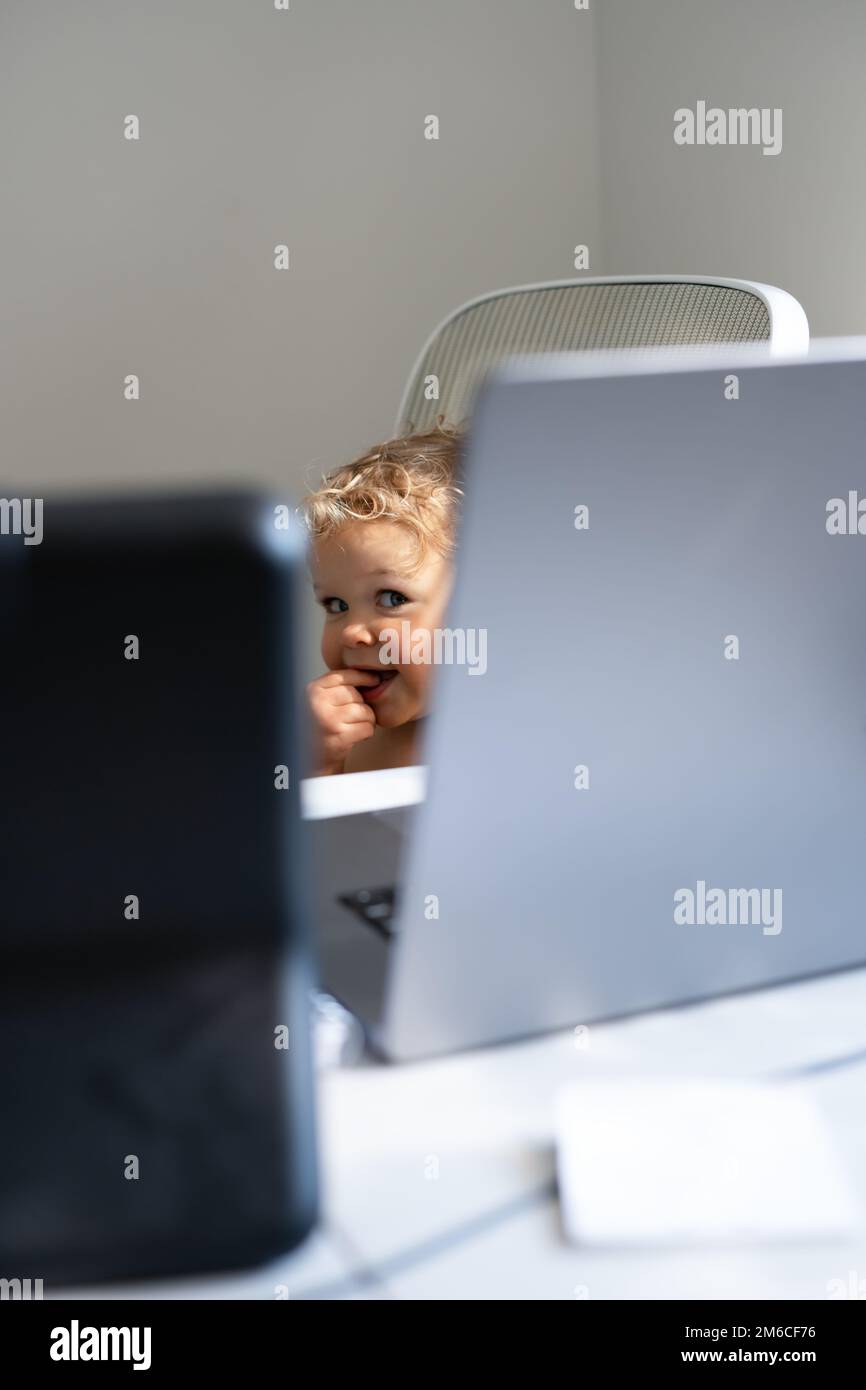 Cute baby boy with laptop computer on the table Stock Photo - Alamy