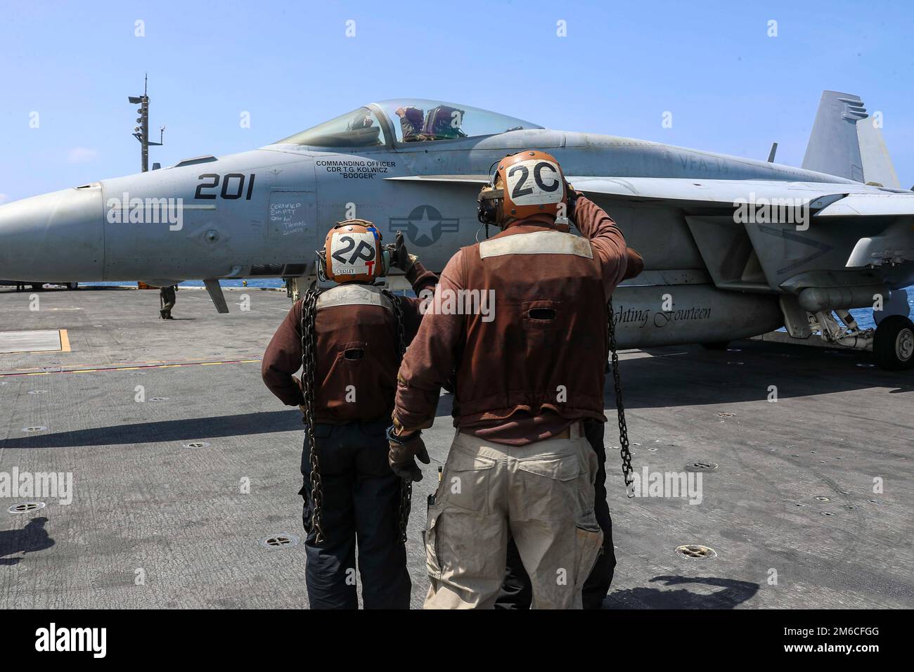 PHILIPPINE SEA (April 22, 2022) Sailors signal Cmdr. Thomas Kolwicz ...