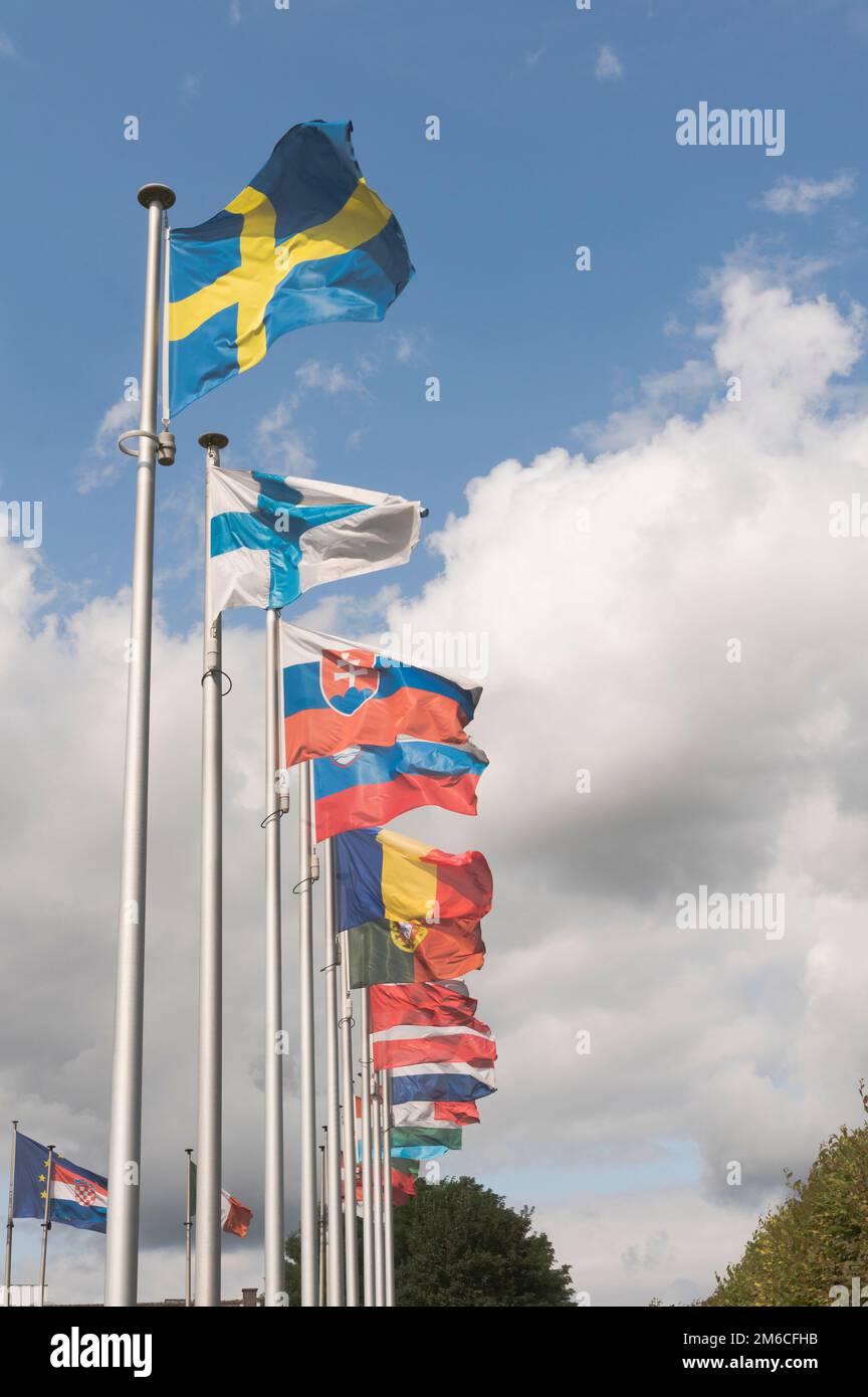 A number of flags of the European Union on a background of blue sky and ...
