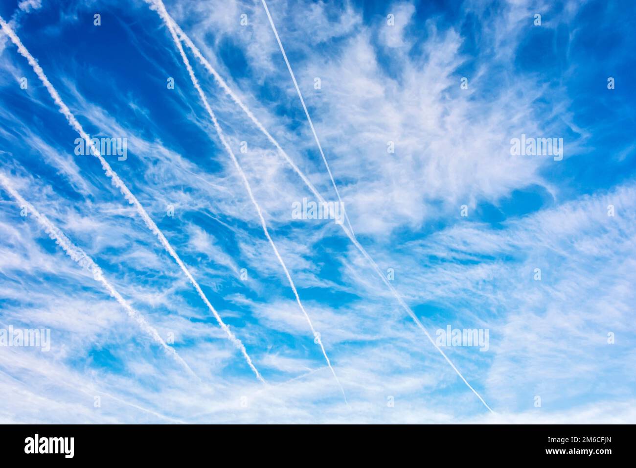 Blue sky with cirrus clouds and traces of aircraft Stock Photo - Alamy