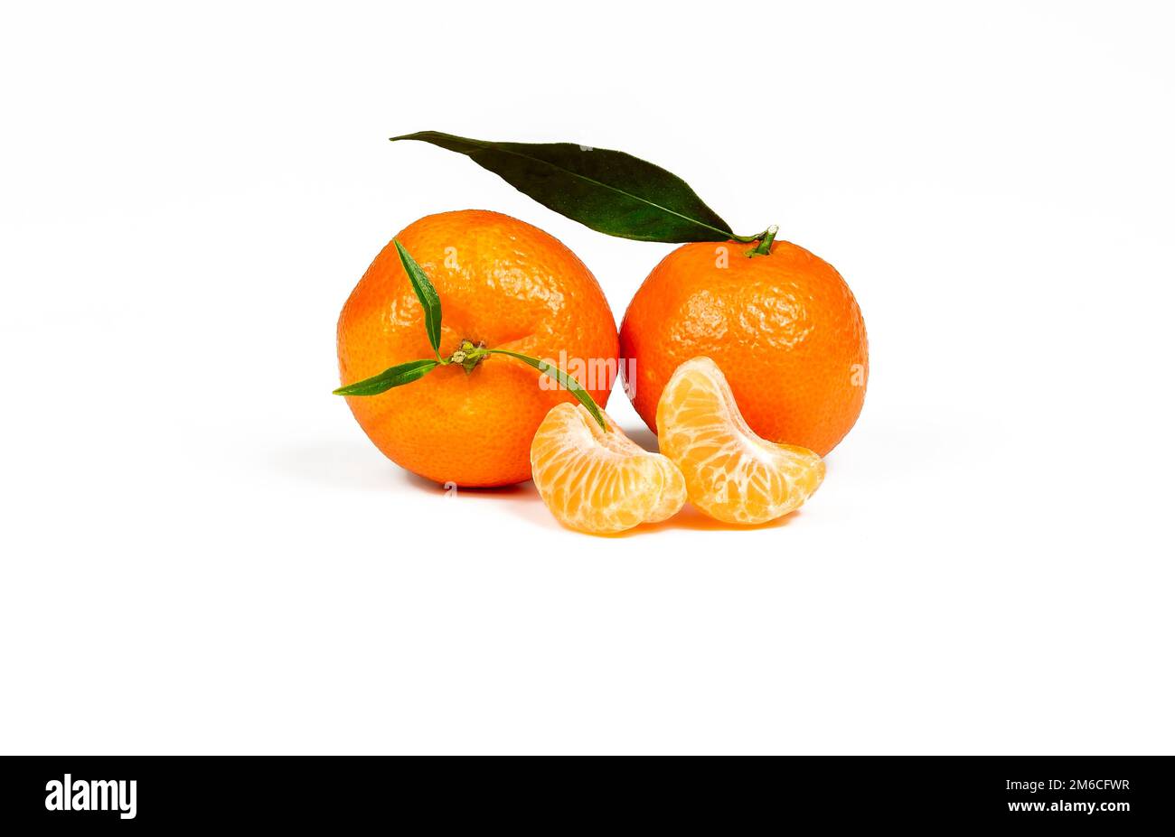 Two orange mandarins and several peeled mandarin Stock Photo - Alamy