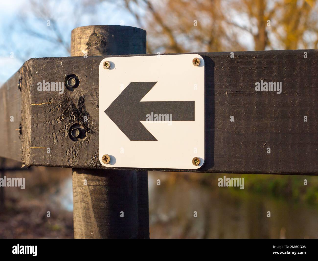 Black and white direction way sign left black wooden post outside close ...
