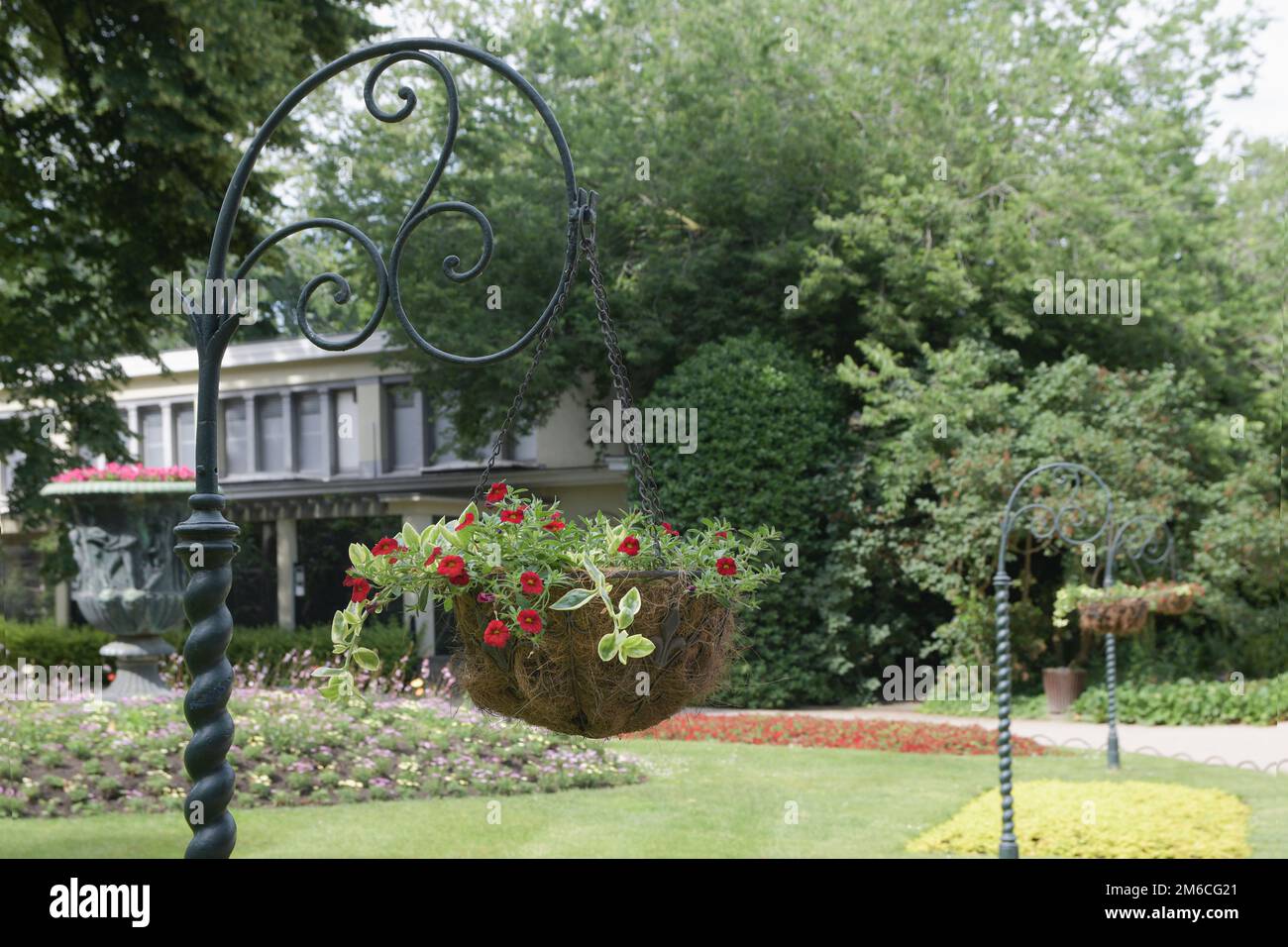 Decorative metal pole for hanging flower beds in the garden Stock Photo ...