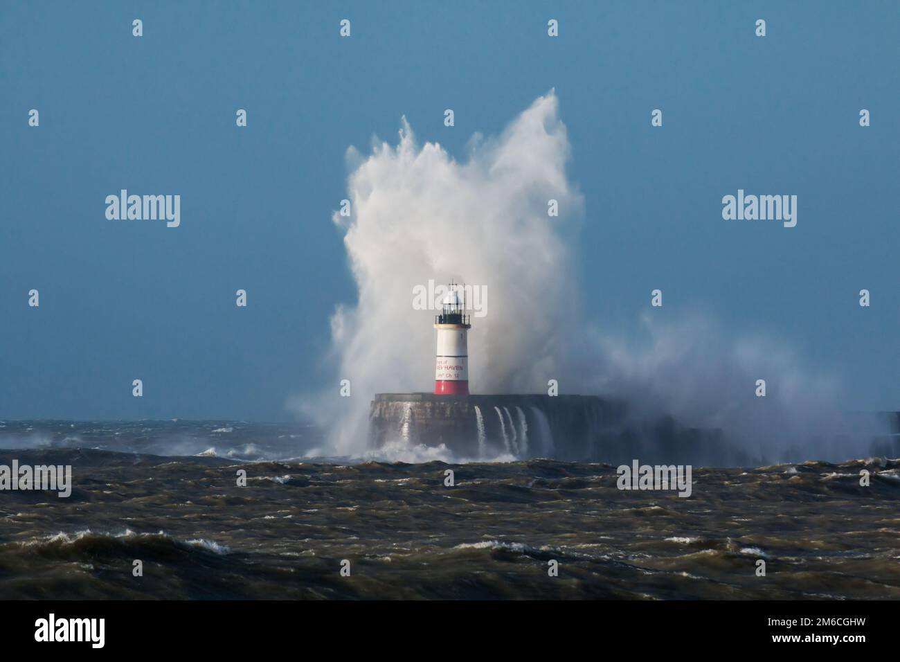 Wave Breaking over Lighthouse Stock Photo - Alamy