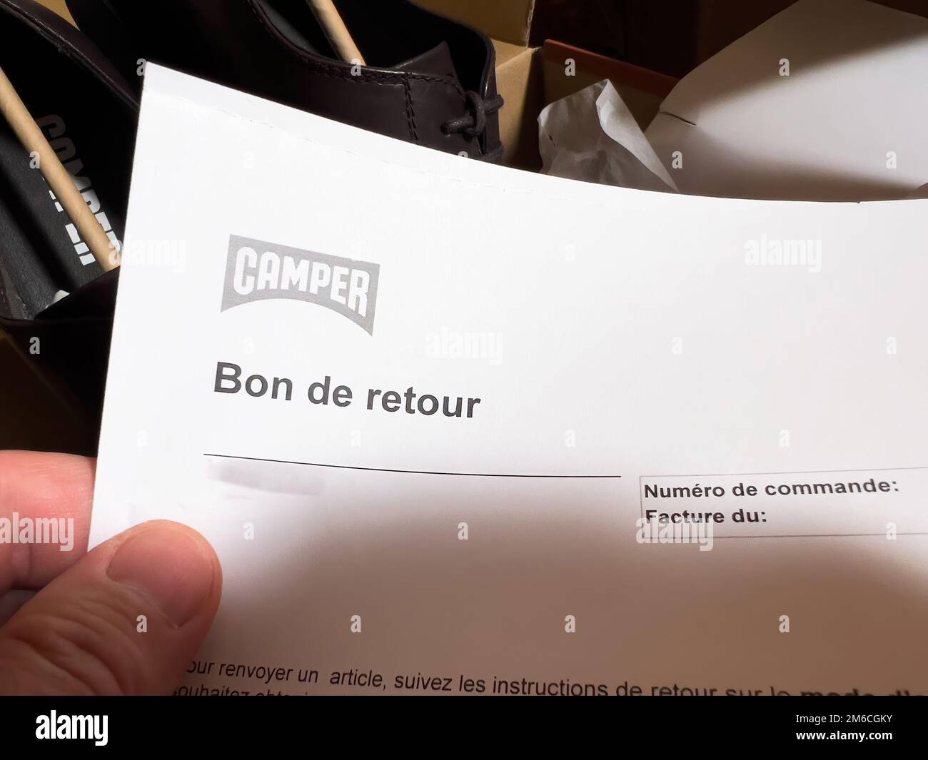 London, October 20, 2022: Personal perspective looking at the invoice isued by Camper Shoes with ...