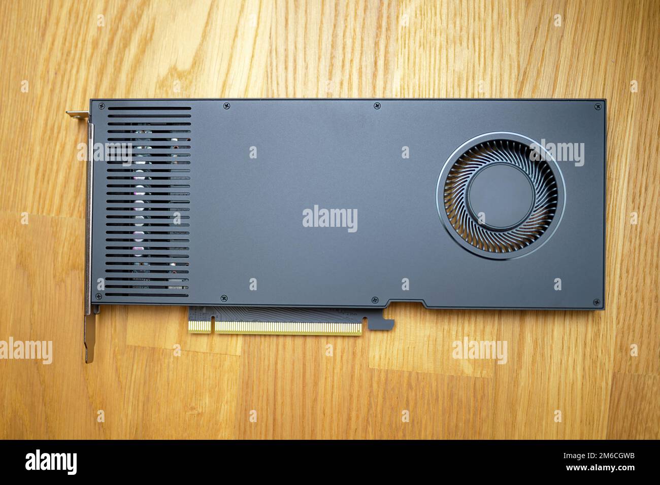 Directly above shot of new GPU video card on wooden parquet floor ...