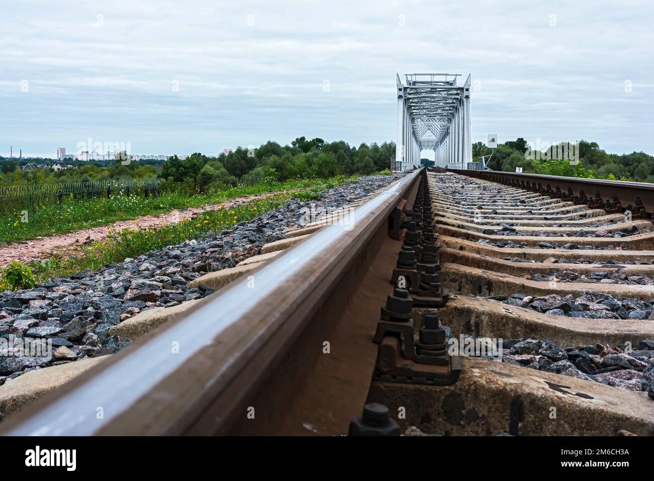 Railroad tracks go into the distance to the railway bridge Stock Photo ...