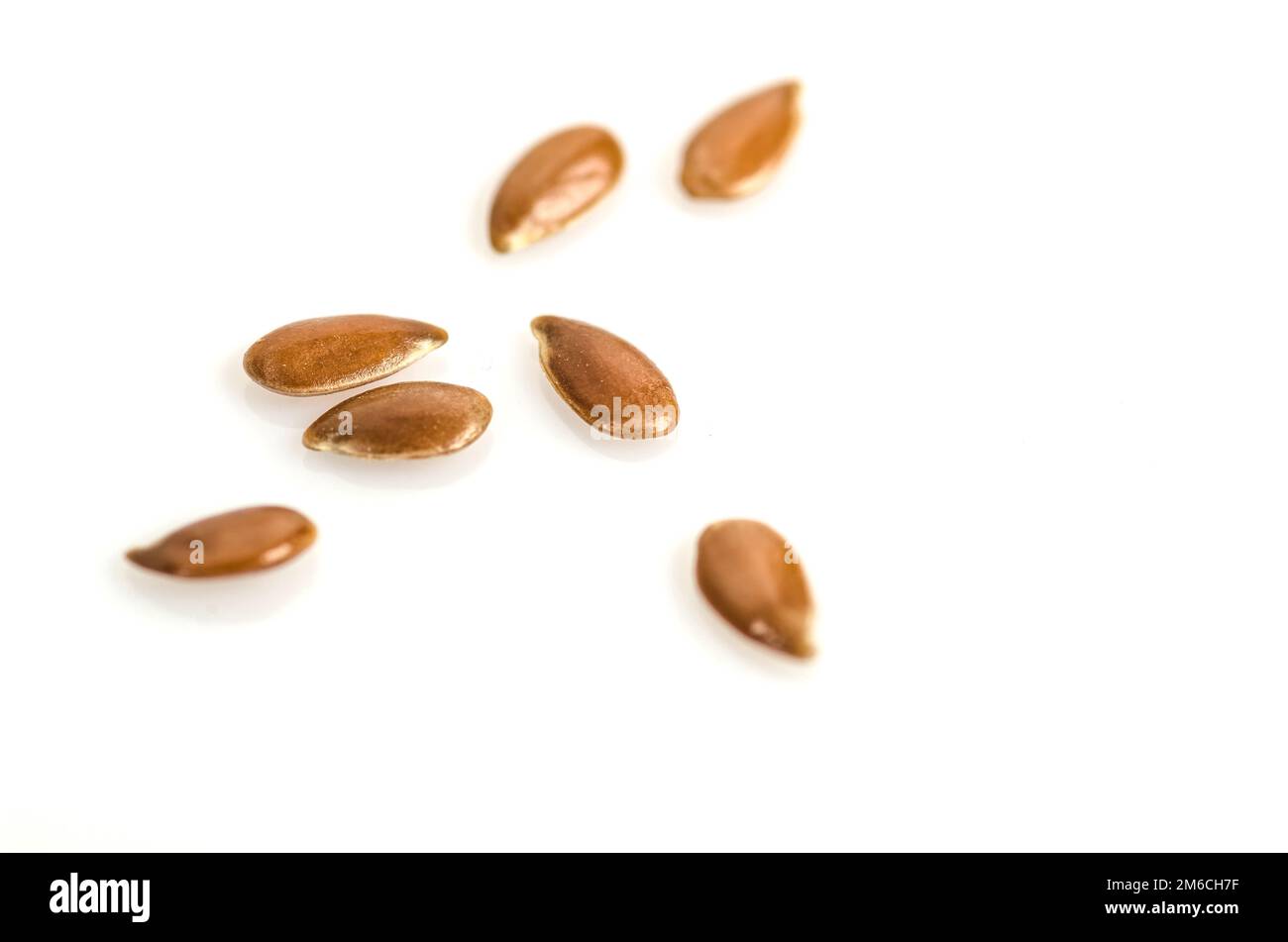 Close up of flax seeds isolated on white background Stock Photo - Alamy