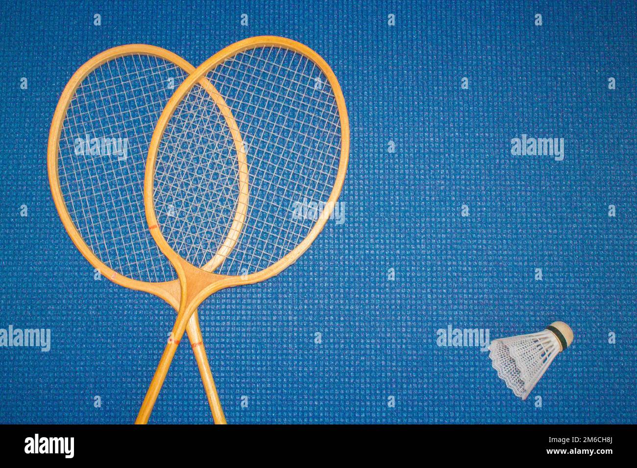 Blue background. Mat for sport, yoga and meditation. Two badminton ...