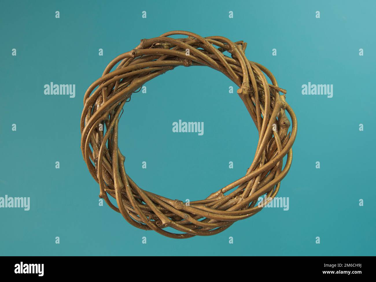 Christmas wreath made of twigs with gilding. Close-up, texture. On a ...
