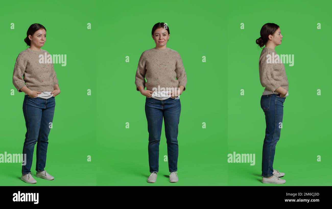 Female model posing on full body greenscreen backdrop, looking at ...