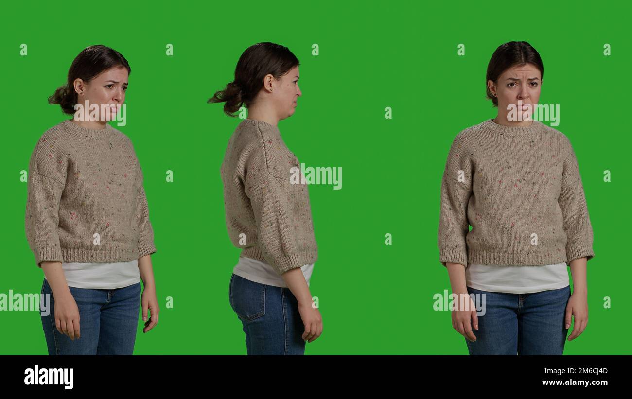 Discontent mad girl acting upset and displeased, posing over green ...