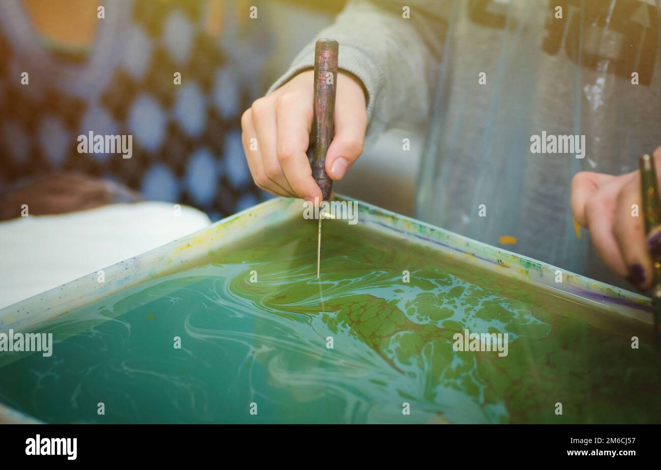 The master teaches the technique of ebru. Hands close up Stock Photo ...