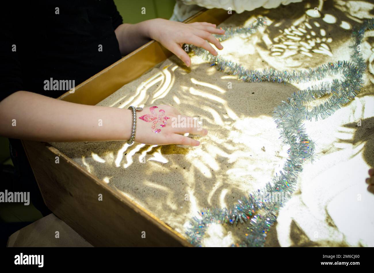 A little kids draws on sand, sand animation, Hands close up Stock Photo ...