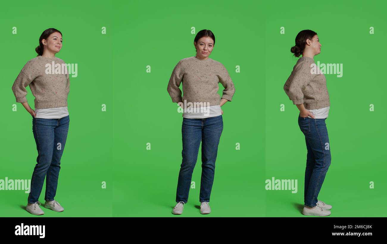 Happy adult posing on full body green screen background, looking at ...