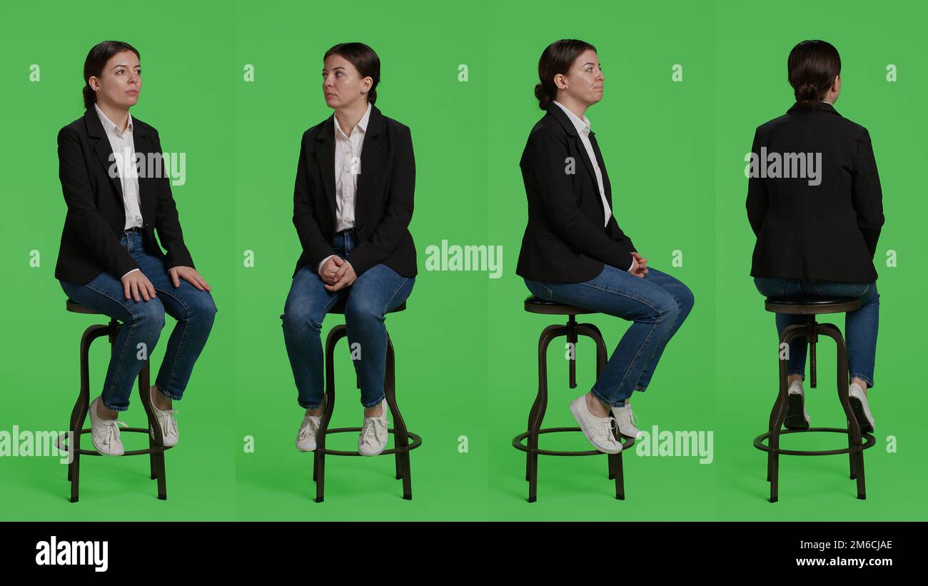 Company employee sitting on chair and waiting on camera, full body ...