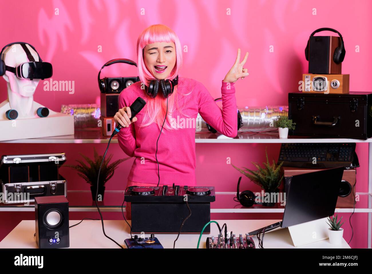 Happy perfomer having fun while playing electronic song at professional ...