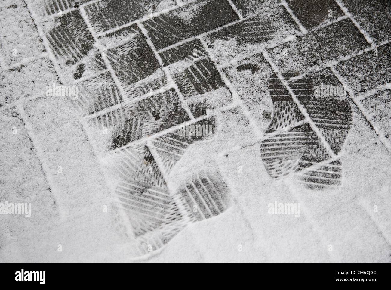 Shoe marks on the asphalt during a snowfall Stock Photo - Alamy
