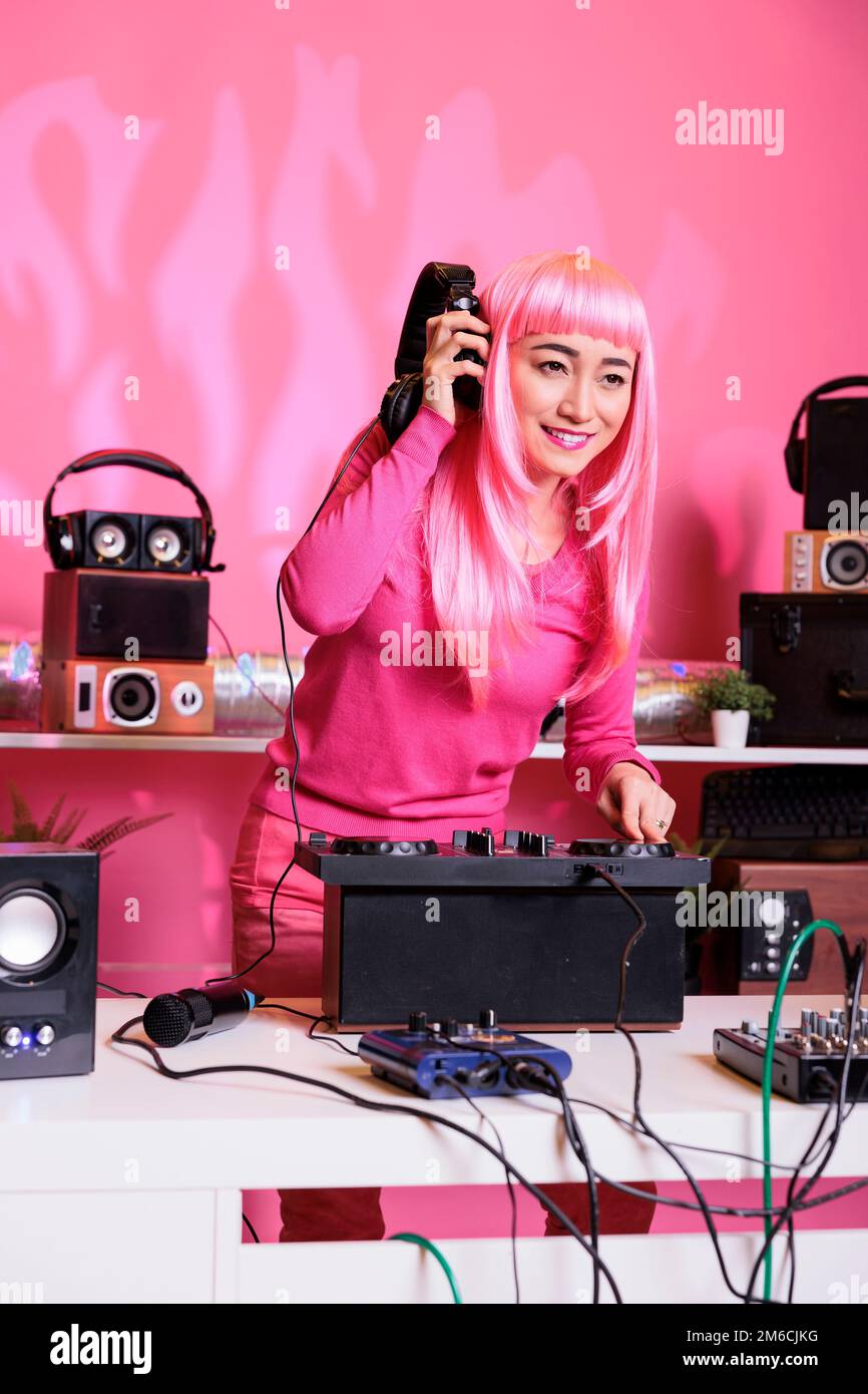 Asian performer mixing electronic sound hi-res stock photography and ...