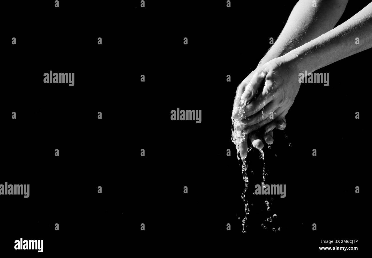 Woman's hands with water splash on black background Stock Photo - Alamy