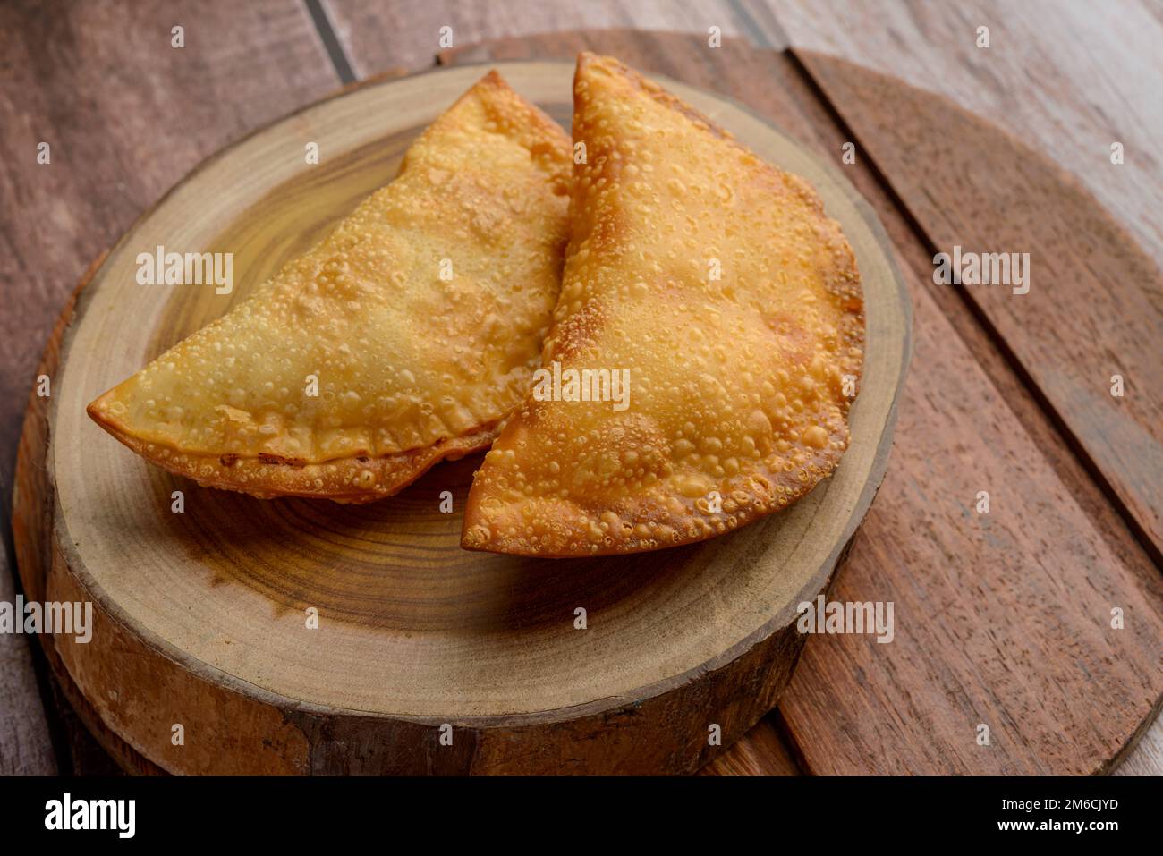 Pastries on wooden background. Traditional Brazilian snack known as ...