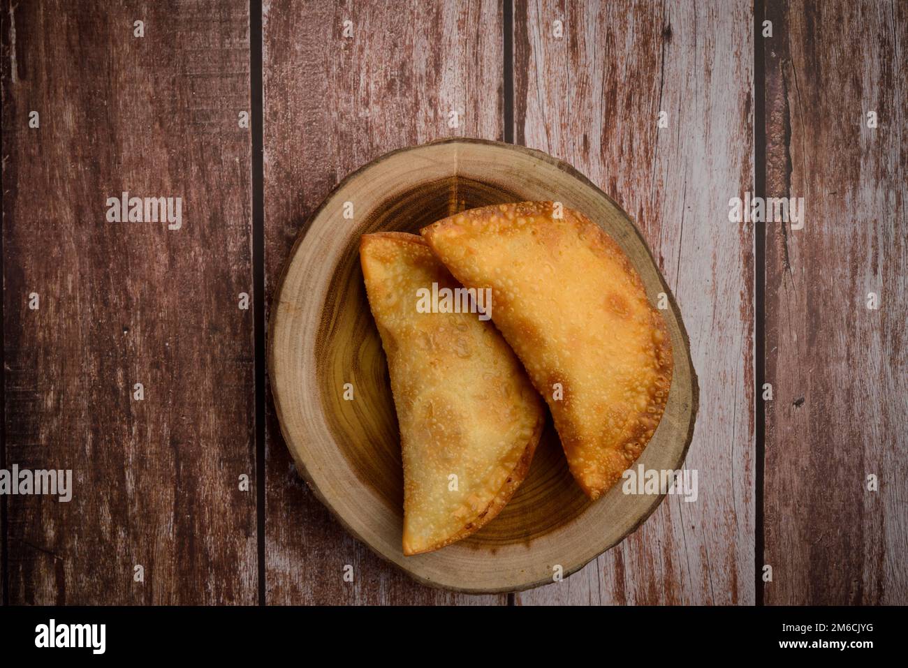 Pastries on wooden background. Traditional Brazilian snack known as ...