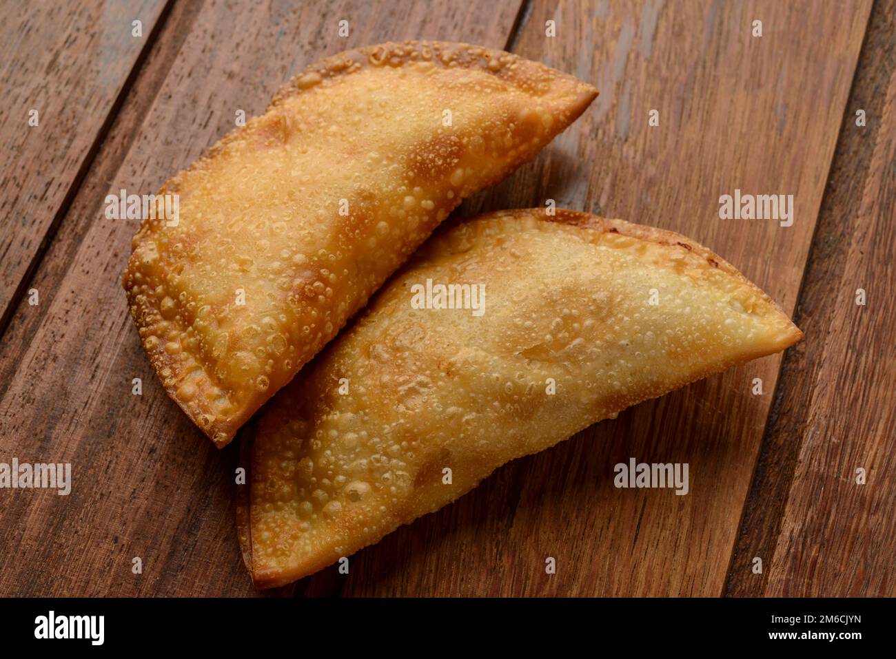 Pastries on wooden background. Traditional Brazilian snack known as ...