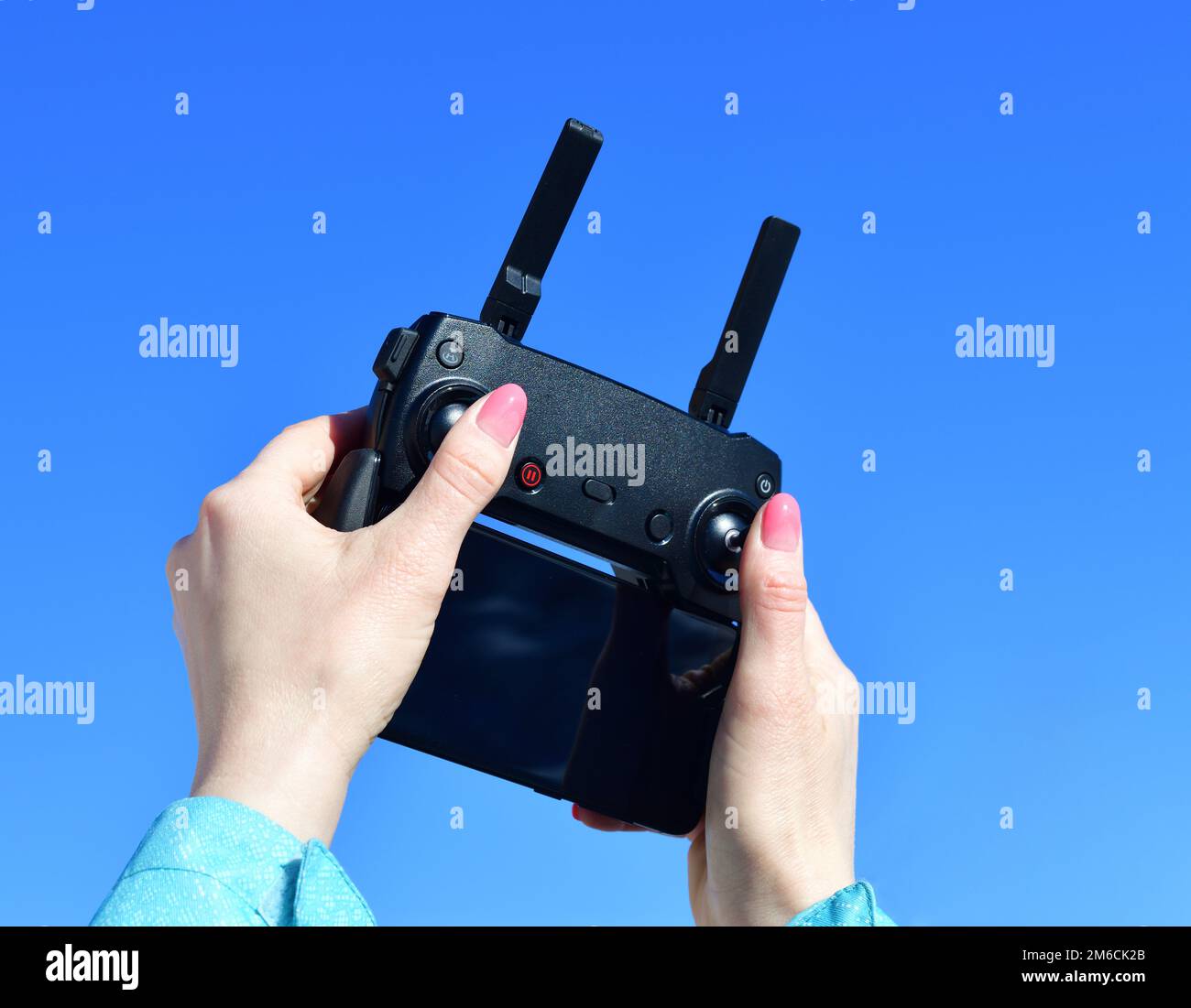 Remote control for quadrocopter with smartphone in female hands Stock ...