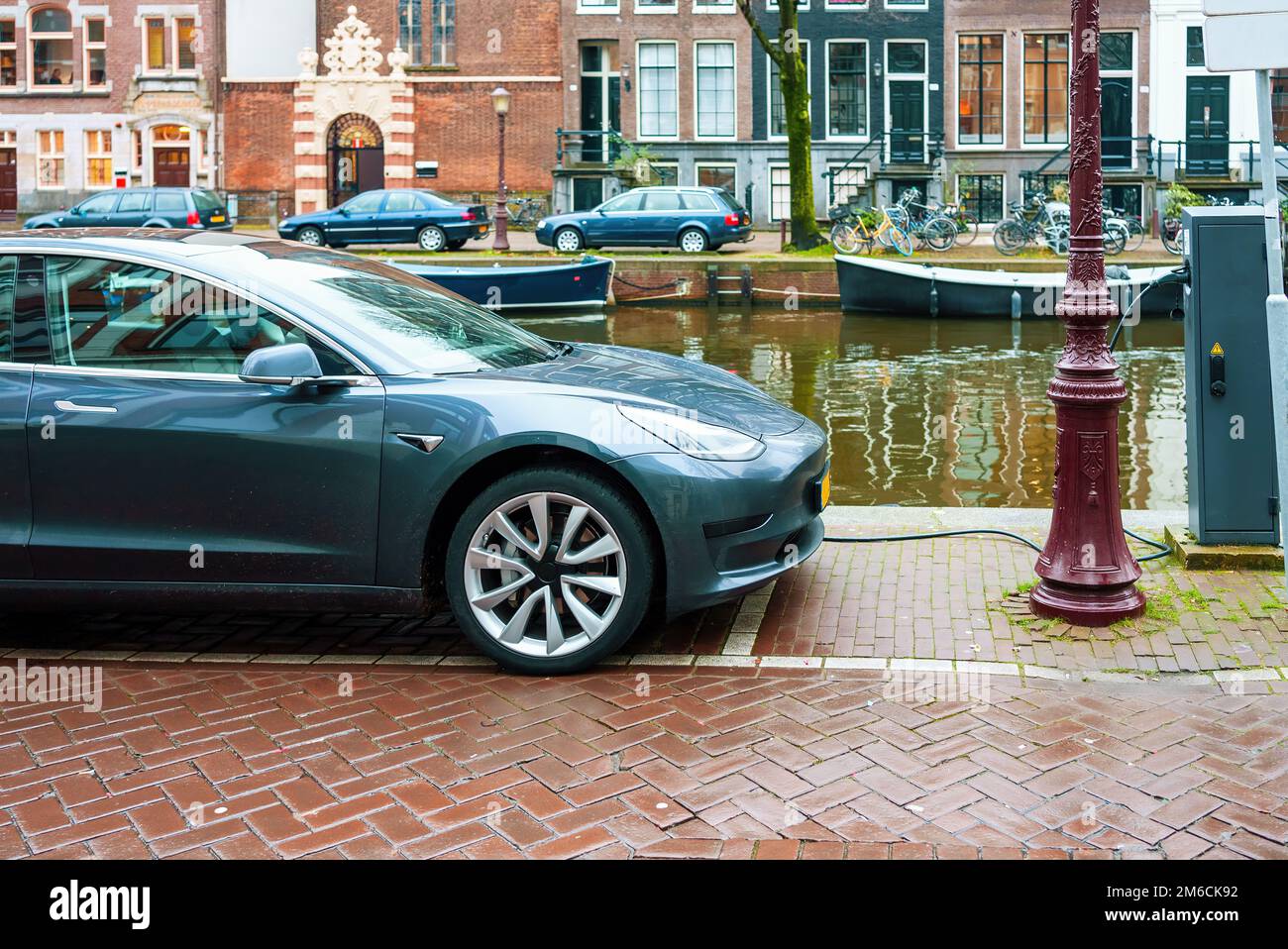 AMSTERDAM, NETHERLANDS, electric car charging at a plug-in charging ...