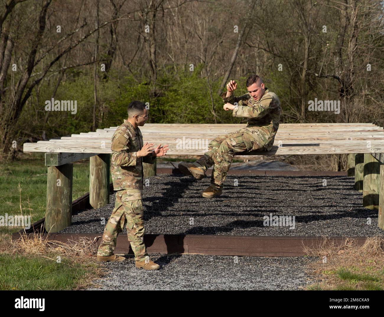 A Soldier encourages his team mate during the obstacle course portion ...