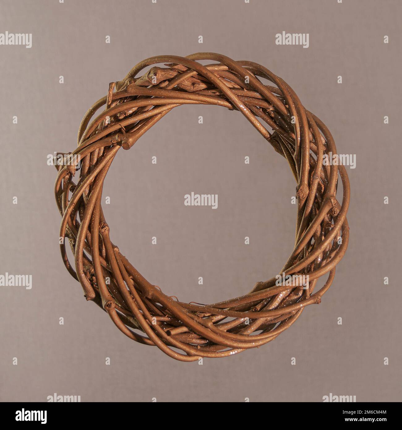 Christmas wreath on a gray background, made of twigs with gilding ...