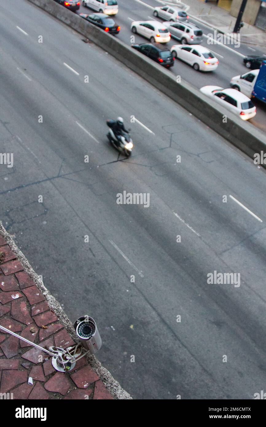 Traffic on an avenue behind a residential building safety camera Stock ...