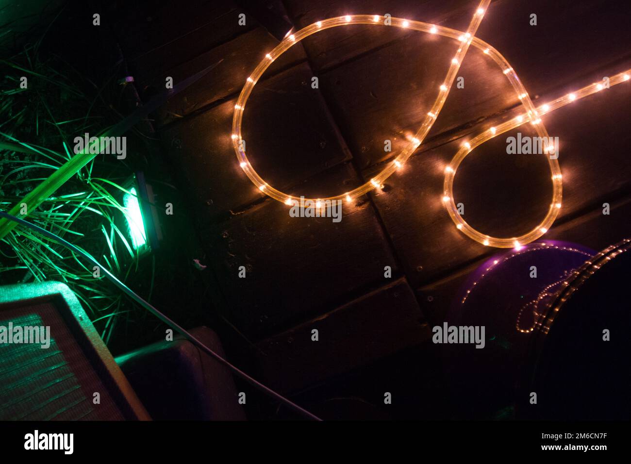 Yellow led strip and green light on a wood stage Stock Photo - Alamy