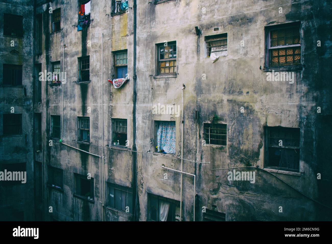 Windows of a condemned building occupied by poor people Stock Photo - Alamy