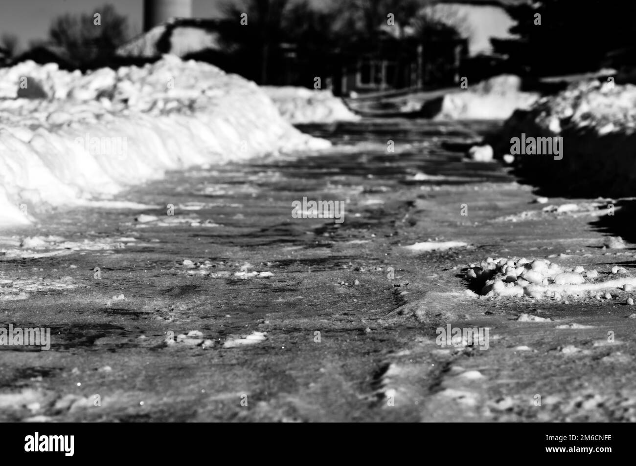 Selective focus ground level view of snow blown sidewalk section with ...