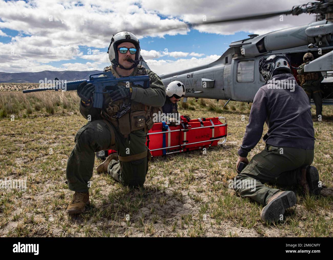 Naval Aircrewman (helicopter) 2nd Class Trey Eaddy, left, acts as ...