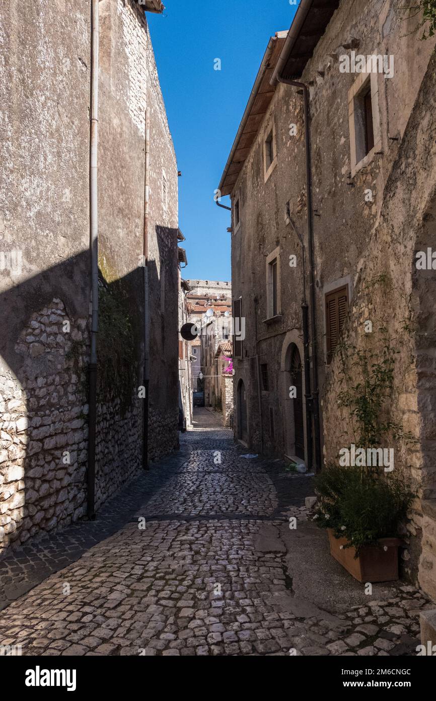 Medieval alley with a castle tower on the background Stock Photo - Alamy