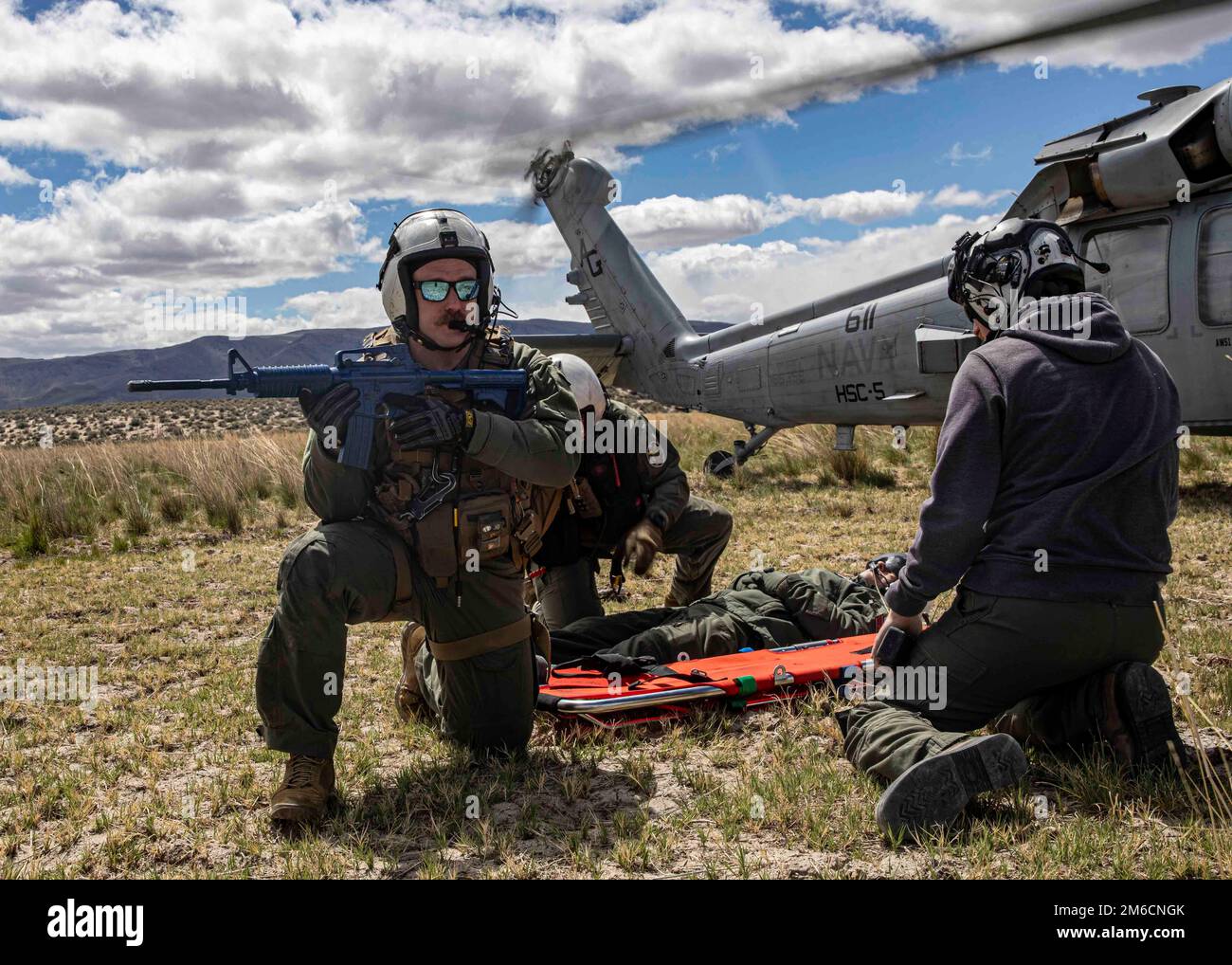 Naval Aircrewman (helicopter) 2nd Class Trey Eaddy, left, acts as ...