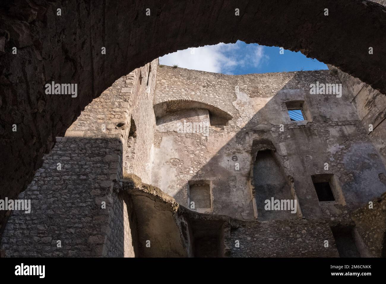 Low angle view of an old stone wall castle with blue sky background ...